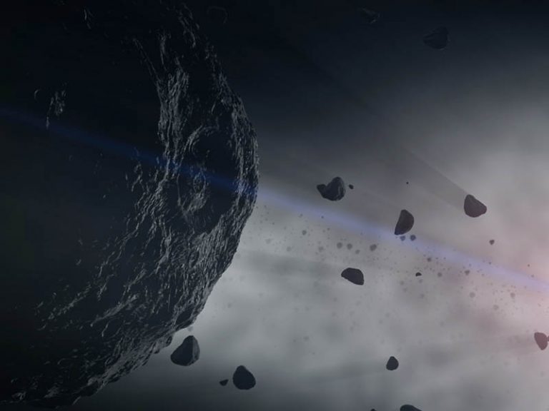 In this illustration, an asteroid breaks apart under the powerful ...